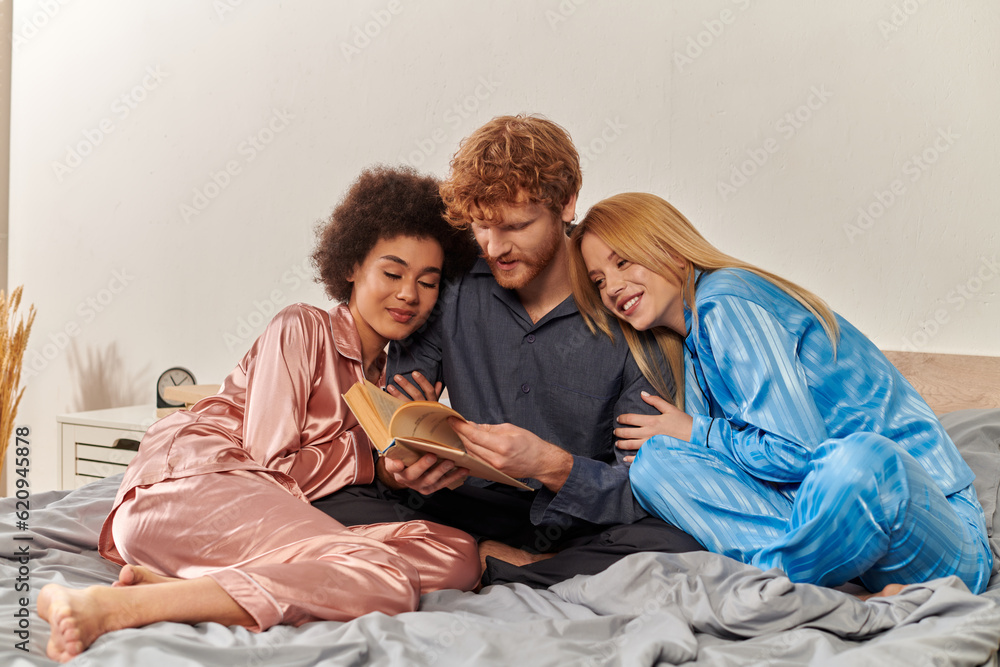 open relationship concept, redhead man reading book next to happy ...