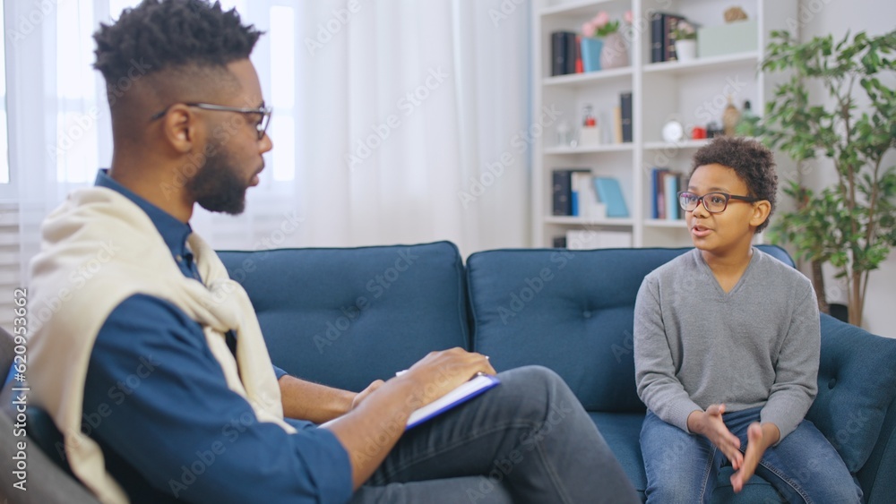 Pre-teen boy talking to school psychologist, adolescent counseling ...