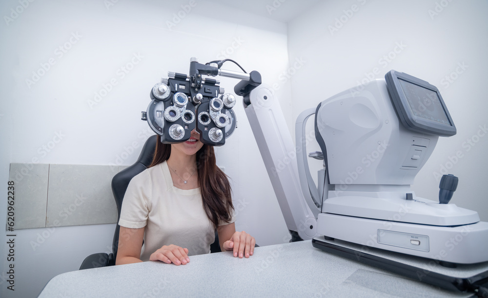 Woman optical shop customer doing eyesight measurement with optical ...