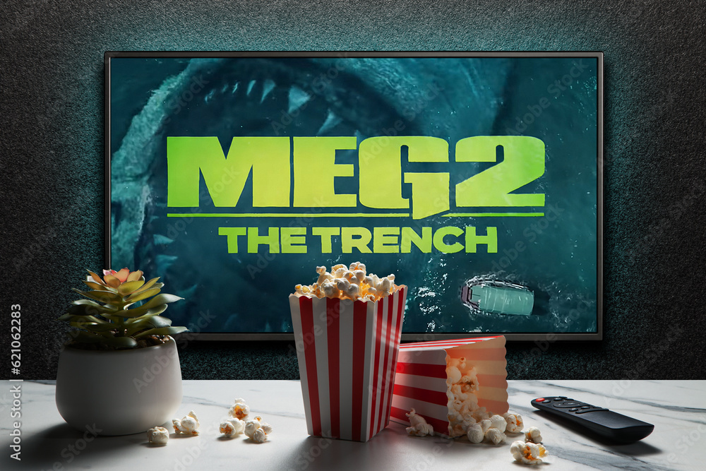 Meg 2 The Trench trailer or movie. TV with remote control, popcorn ...