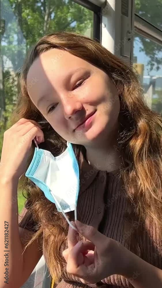 girl takes off her mask teenage girl brown hair is slenderin subway ...