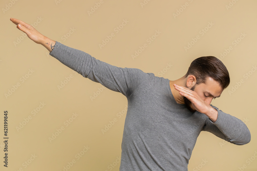 Trendy cheerful lebanese man having fun dancing and moving to rhythm ...