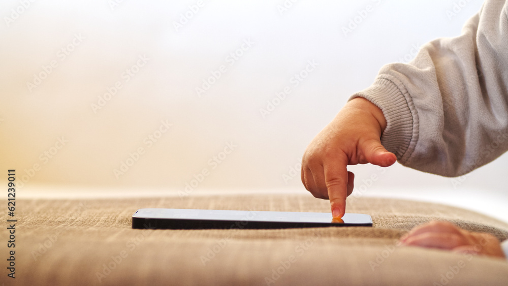 Child's finger pressing, scrolling, tapping on mobile phone screen ...