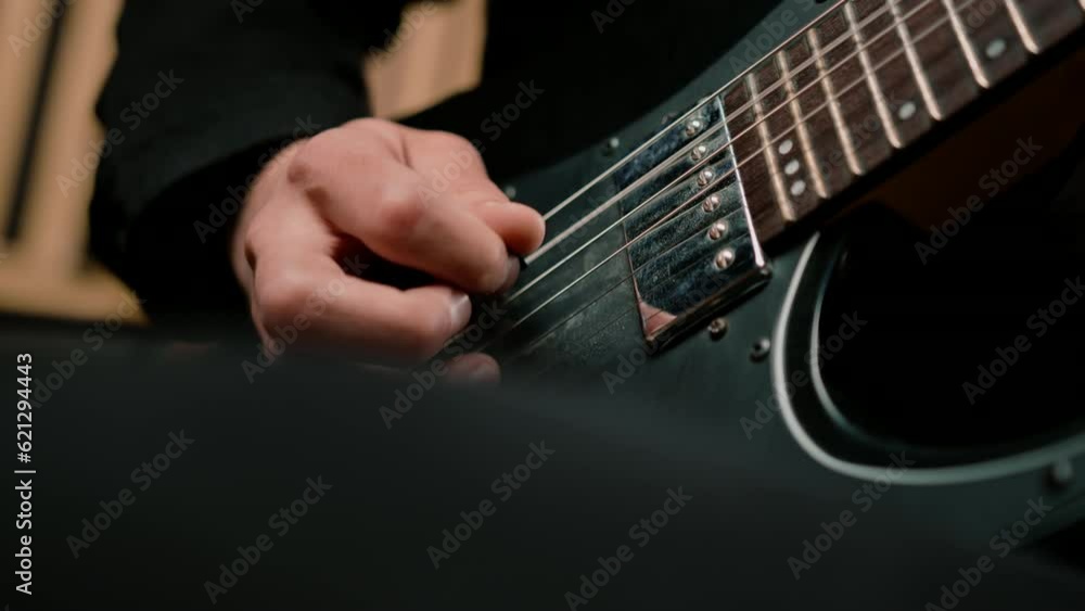 rock performer with electric guitar in recording studio recording ...