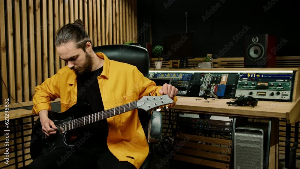 rock artist with electric guitar in recording studio recording playing ...