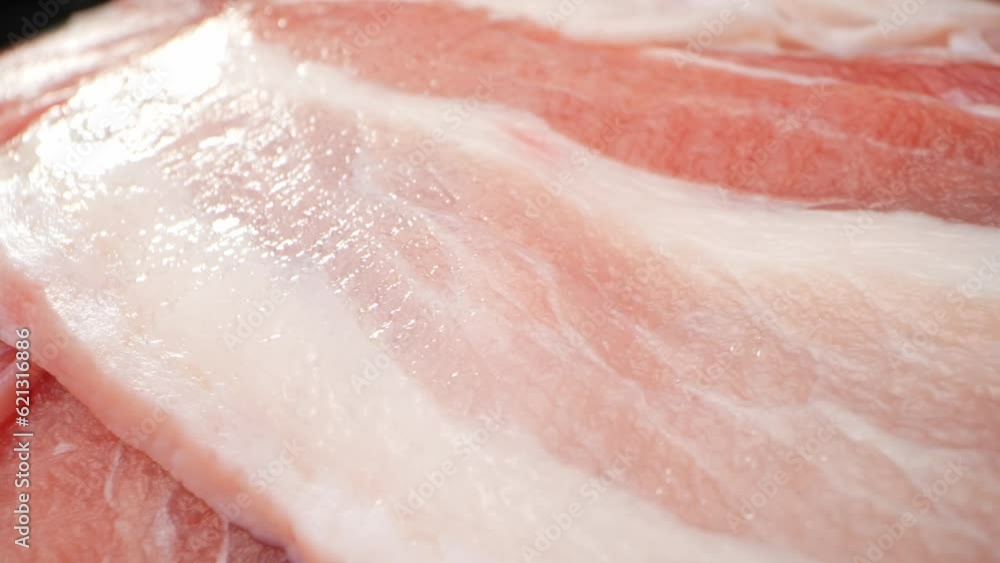 Mesmerizing macro video showcasing raw pork belly slices. Captured with ...
