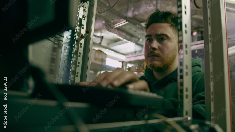 focused hacker in data center hacking software system vulnerable cyber security server room ...