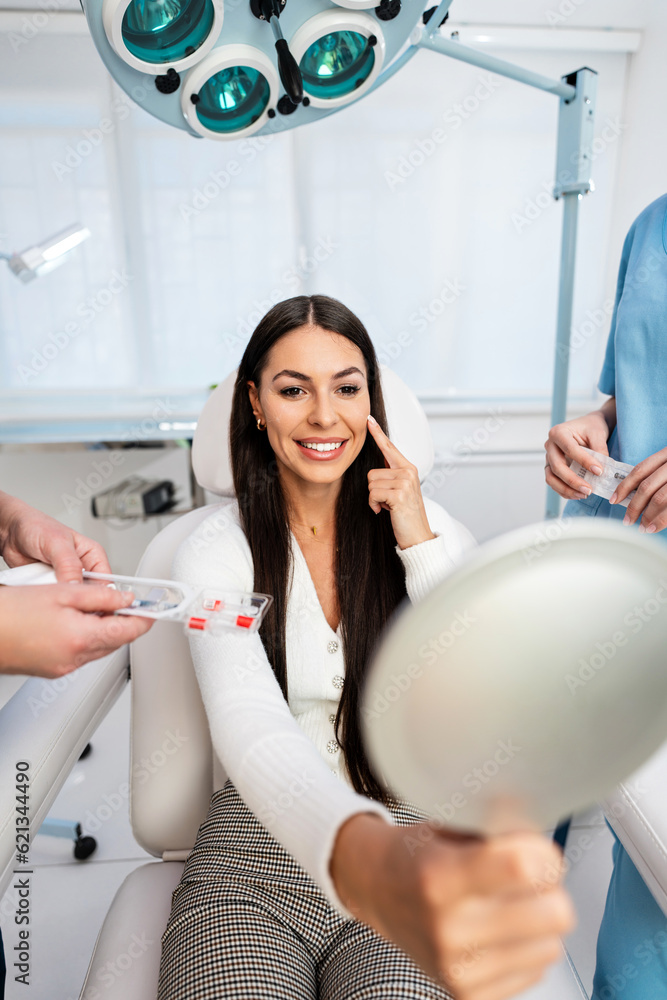 Beautiful and happy brunette woman at beauty medical clinic. She is ...