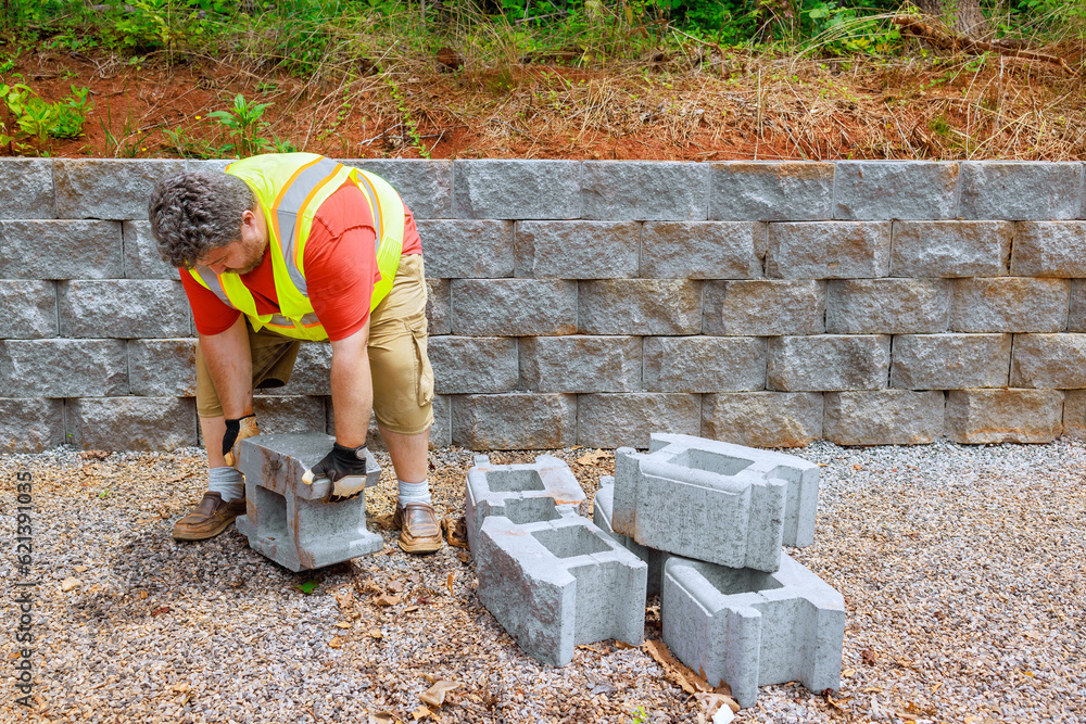 As construction worker lifted concrete block, to ensure its proper ...