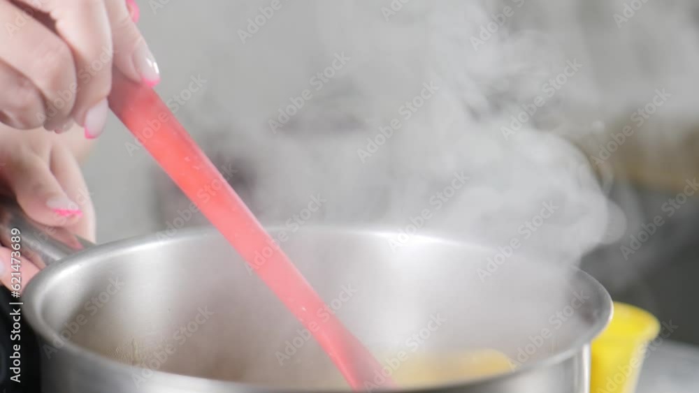 Steam or Vapour clouds rising from boiling water in saucepan on stove ...