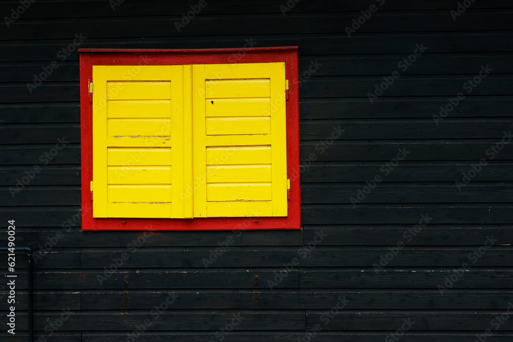 Small window of a wooden house in a small town in Austria. Retro style ...