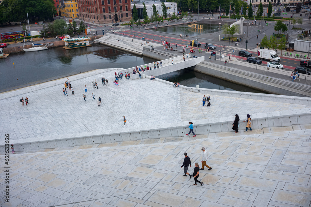 Tourists explore the Oslo Opera House, which was built in 2008 with the ...
