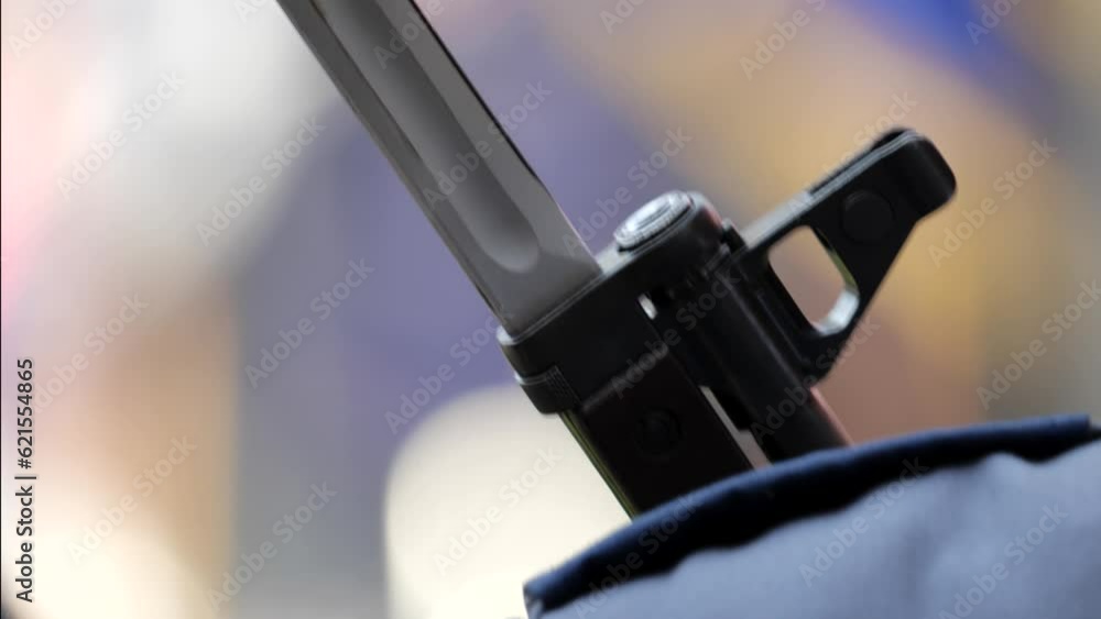 Anonymous man holding up a machine gun with a bayonet attached, detail ...