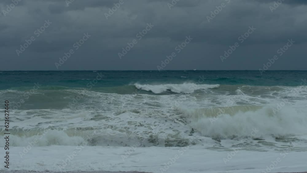 Stormy weather and dark sky. Power of ocean. Tidal surge on extremely ...