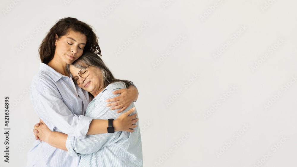 Positive adult woman hugging elderly lady, enjoy love, lifestyle ...