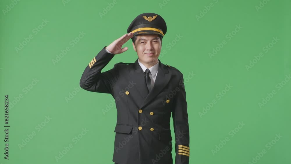 Asian Man Pilot Is Respectful, Saluting While Standing In The Green ...