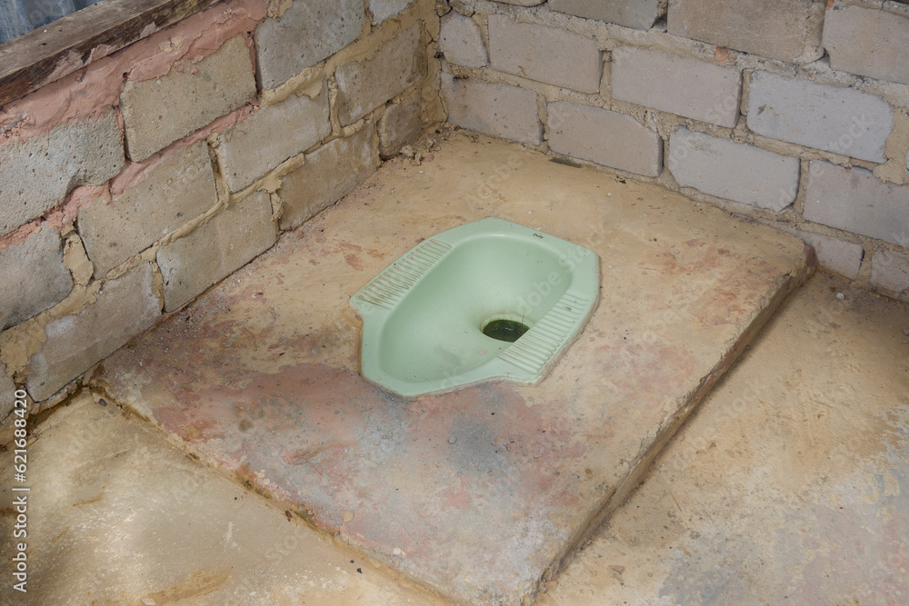 a simple squat toilet that is often used by Asians, especially in ...