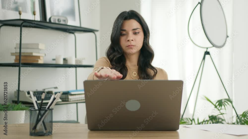 Portrait of hispanic woman turning off laptop and closing lid of ...