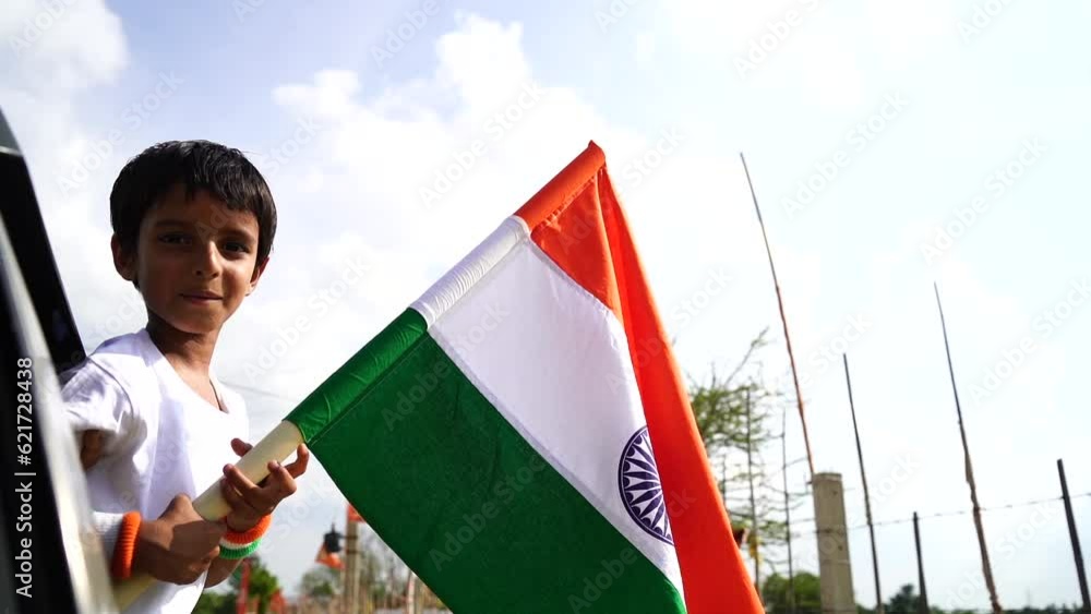 Cute little boy holding Indian flag in his hands and smiling ...