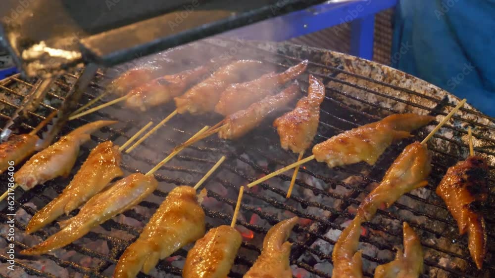 Asian thailand night market street food booth grilled chicken wings ...