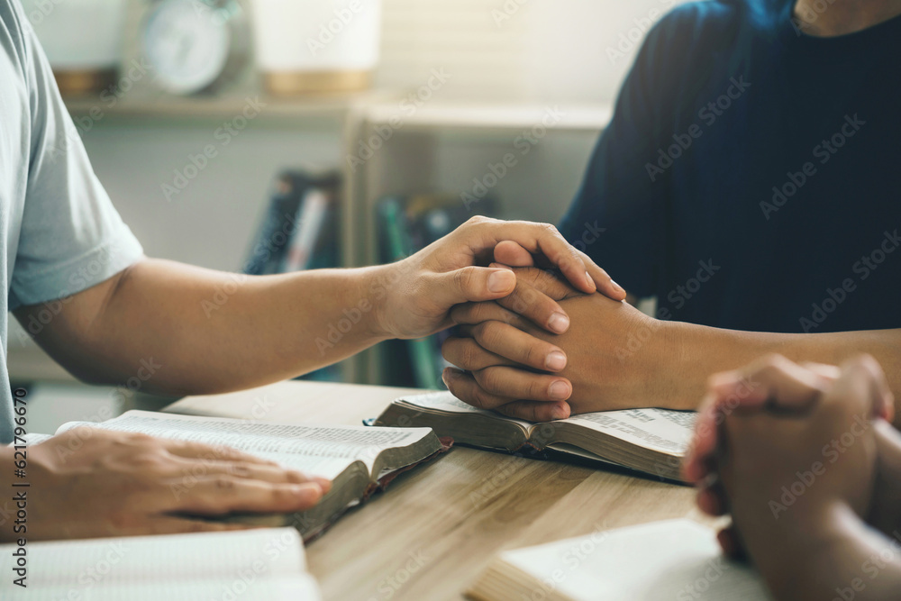 Christian group of people Holding hands together and praying on the ...