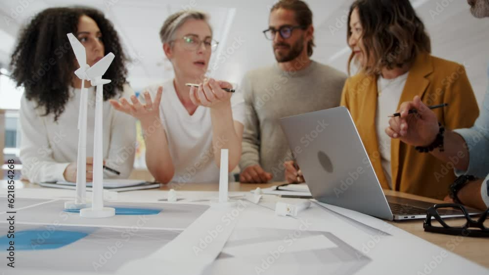 Creative business team having a meeting in an office, discussing a wind ...