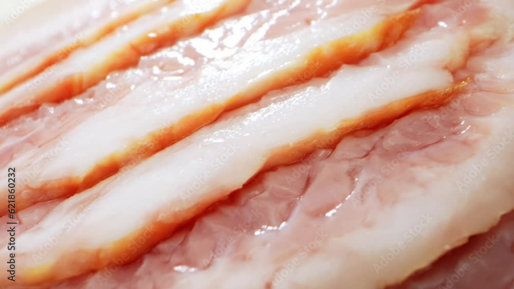 Mesmerizing macro footage captures the sizzling essence of raw bacon ...