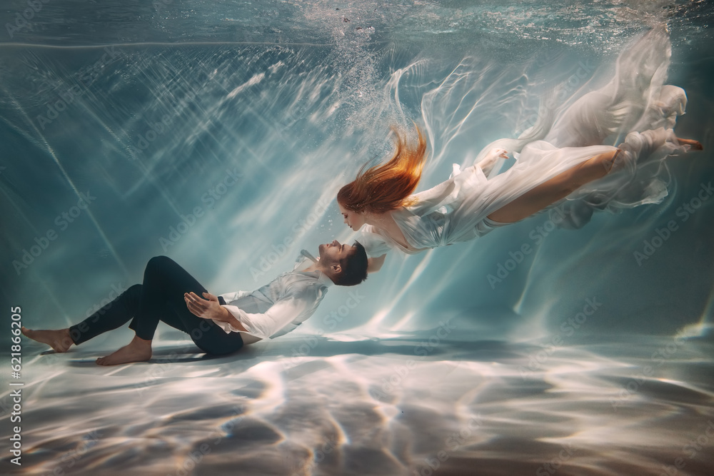 Happy couple in love swim underwater, female goddess muse inspires male ...