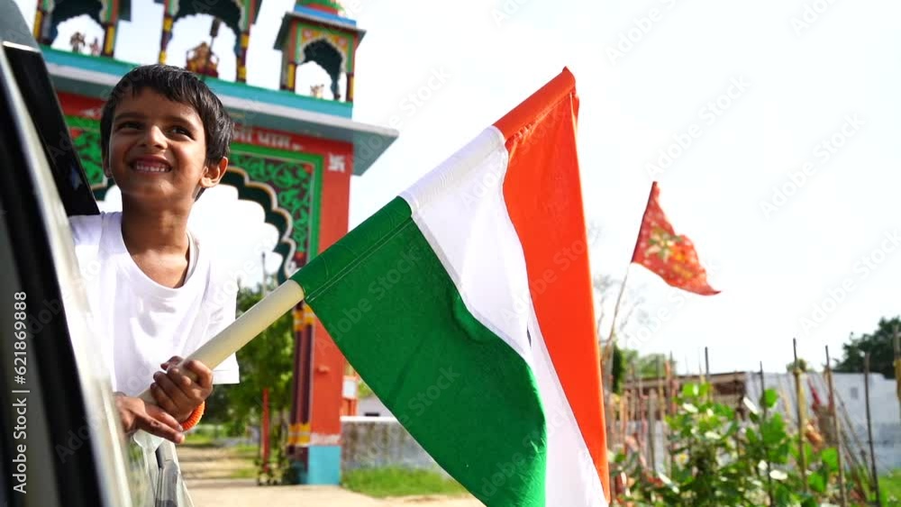 Cute little boy holding Indian flag in his hands and smiling ...