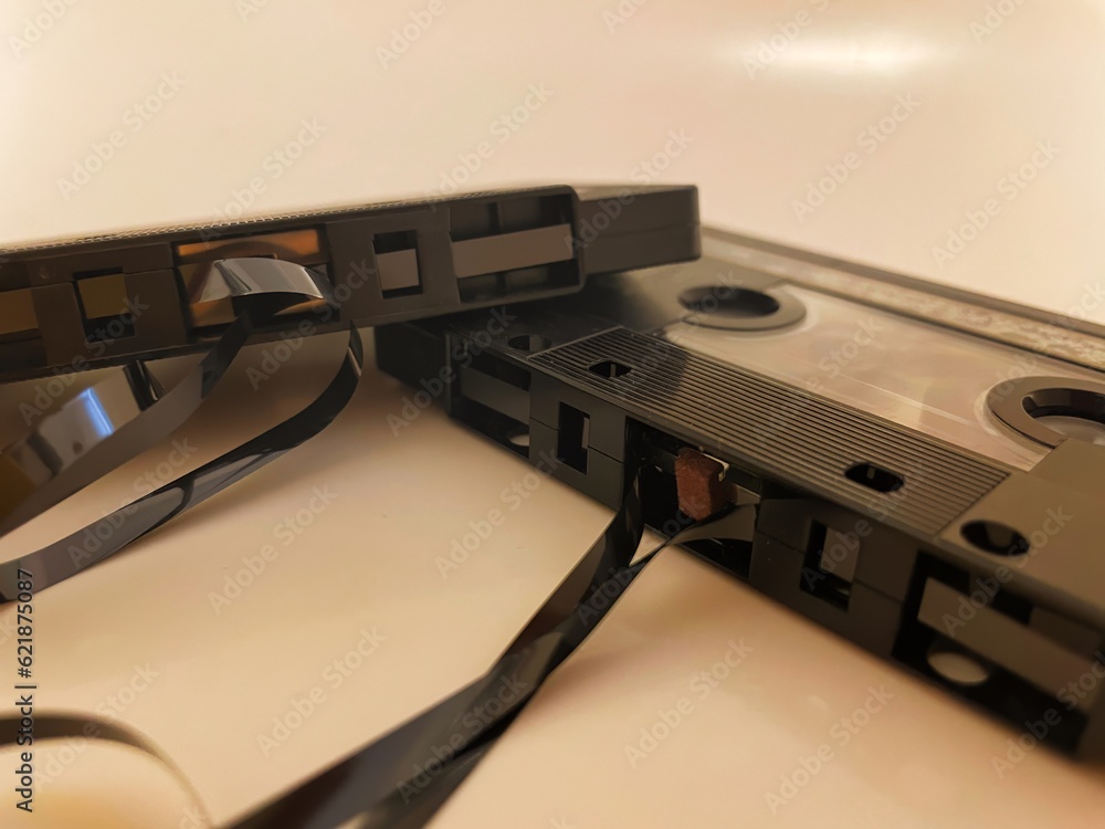 different cassette tapes with broken tape laying around ready to ...