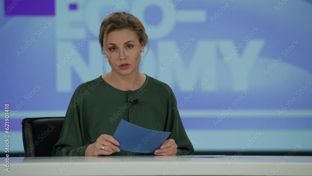 Caucasian female anchorwoman reporting on a story in live news studio ...