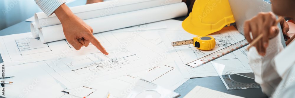 Engineer partner drawing and working on blueprint design together on ...