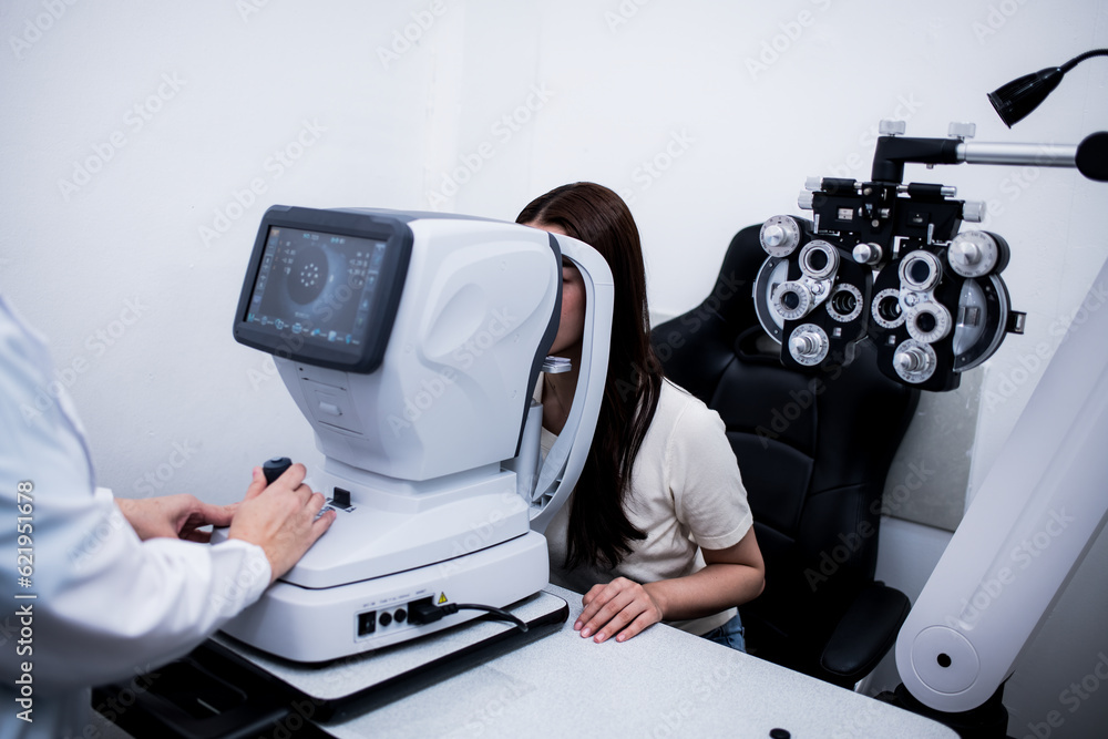 Woman optical shop customer doing eyesight measurement with optical ...
