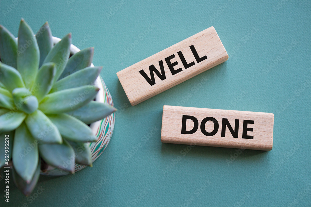 Well done symbol. Wooden blocks with words Well done. Beautiful grey ...