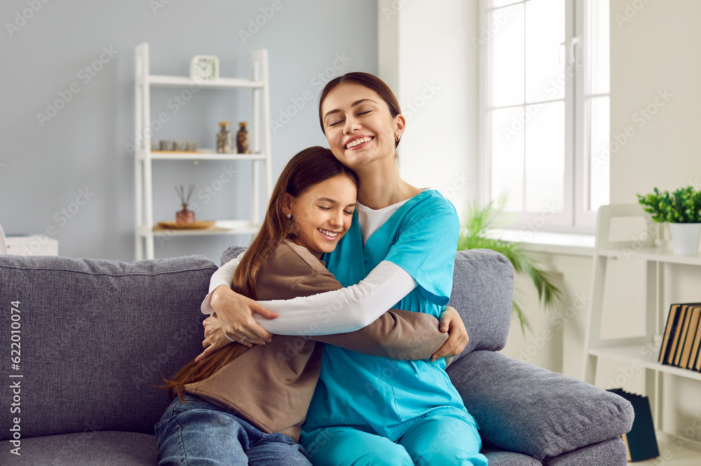 Happy child hugs doctor. Happy, smiling woman pediatrician in uniform ...
