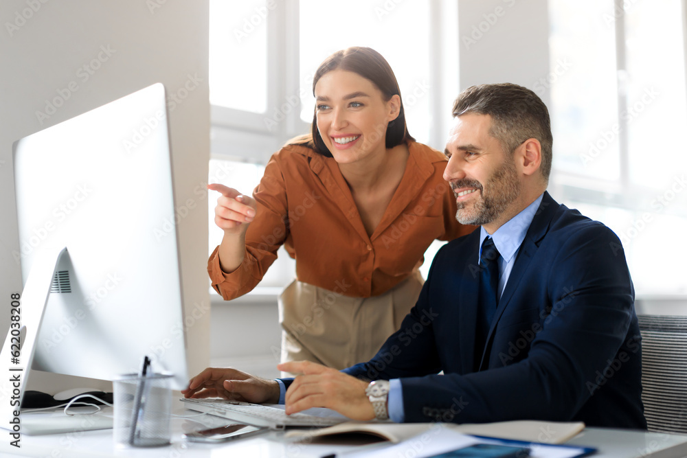Happy coworkers management team lady and man looking at computer screen ...