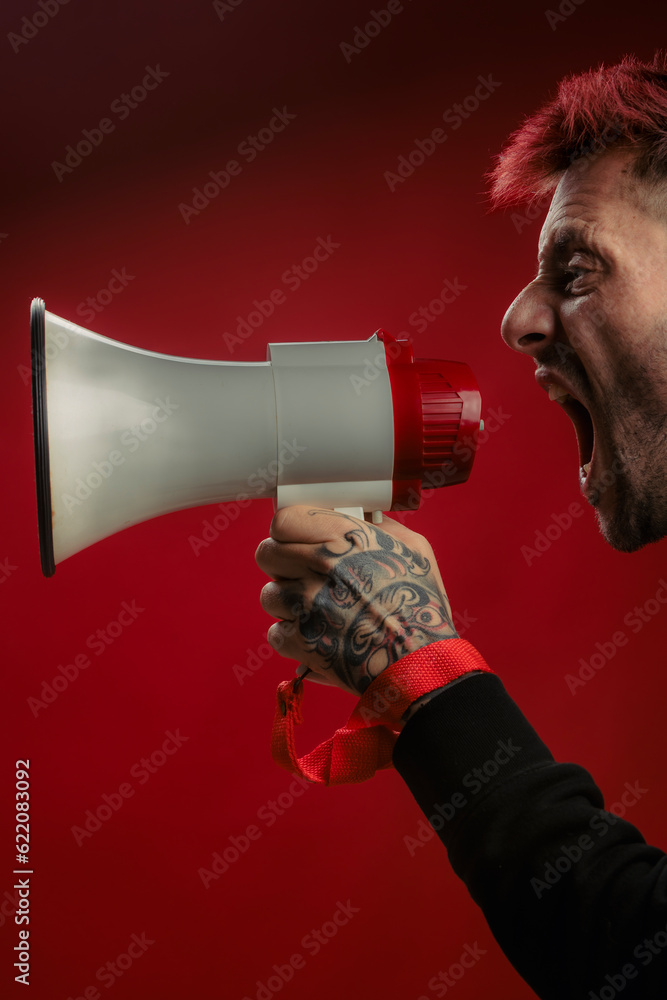 Angry man holding megaphone over red background Stock Photo | Adobe Stock