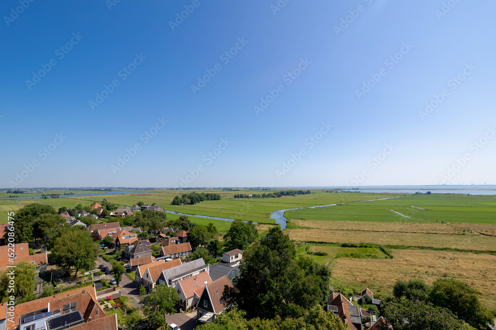 Typical Dutch polder in summer, Canal or ditch and green meadow ...
