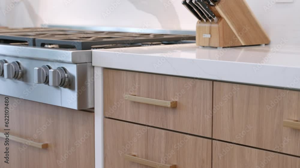Close up of wooden kitchen drawers under white marble worktop and built ...