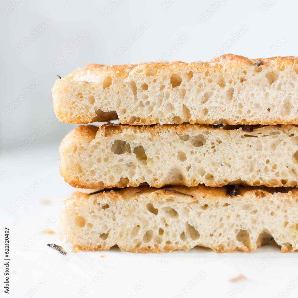 Cross section of homemade onion focaccia on a white background,sliced ...