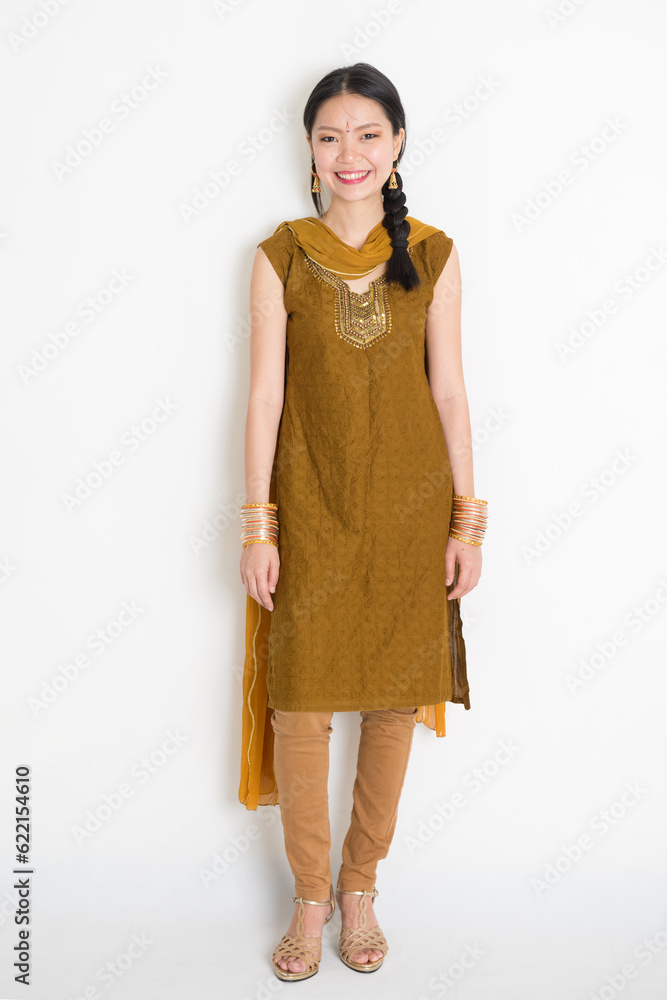 Portrait of young mixed race Indian Chinese girl in traditional punjabi ...