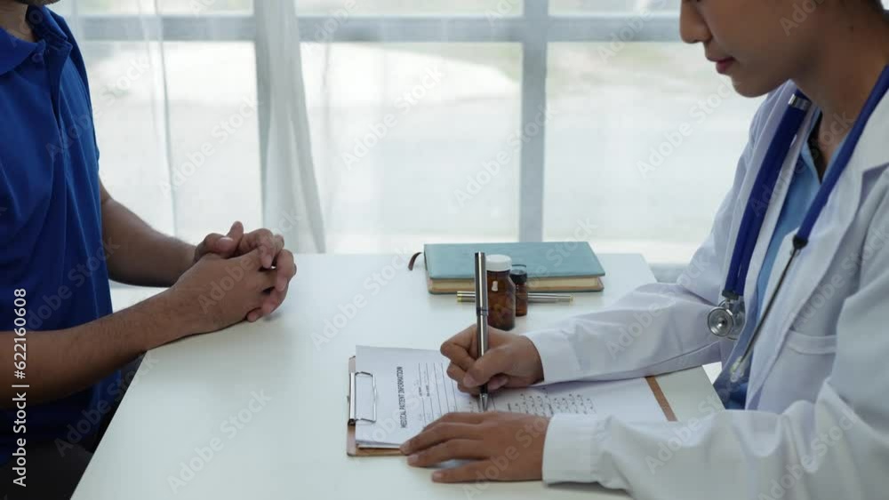 A female doctor is questioning the patient's symptoms of left-sided ...