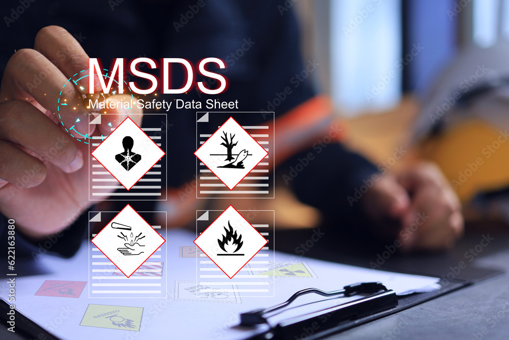 Safety officer writing on MSDS or material safety data sheet to ...