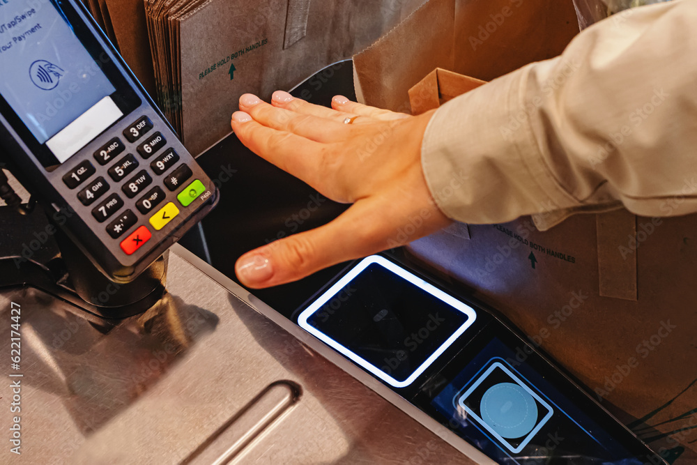 Female hand scanning her palm to pay with modern wireless payment ...