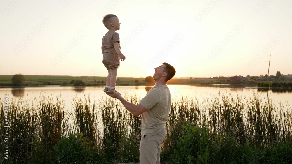 The trust of the son to the father. The father holds his son in full growth in the palm of his ...