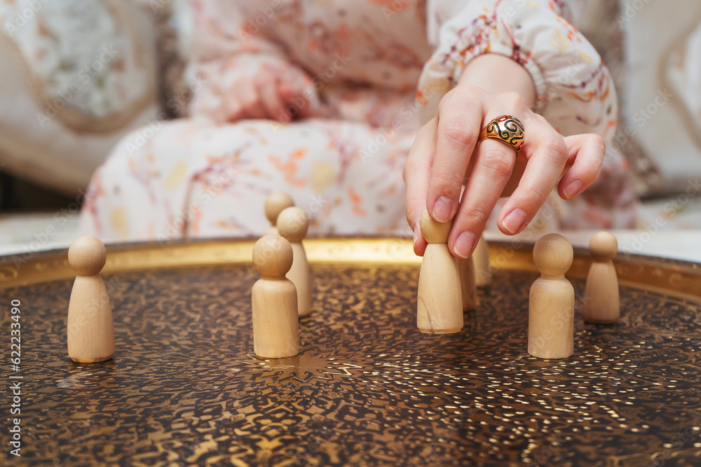 girl with wooden figurines of people on the table. subject photo ...