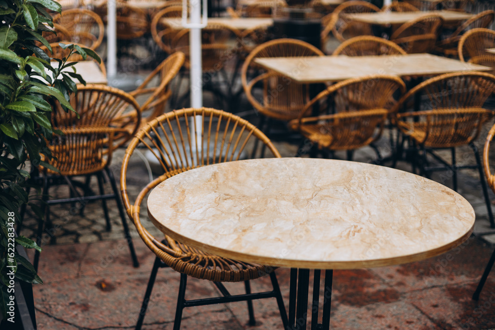 Outdoor street cafe tables ready for service. Empty cafe terrace with ...