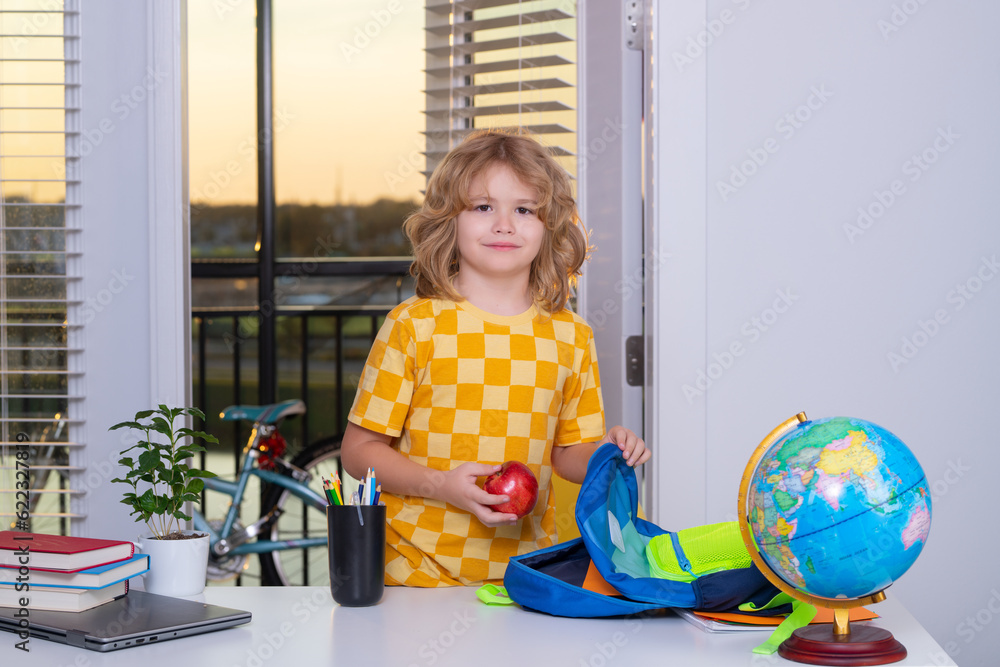 Nerd pupil doing homework puts school supplies in a backpack. Clever ...