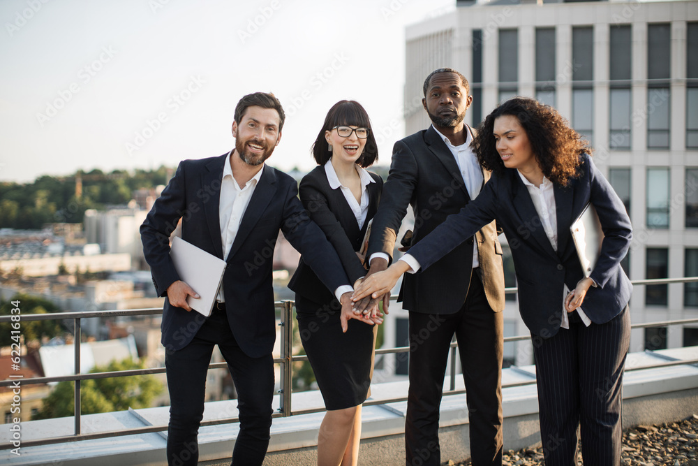 Foto de Portrait of cheerful business partners of different ...