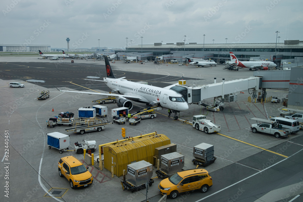 Air Canada planes connected to sleeves and airport equipment at Toronto ...